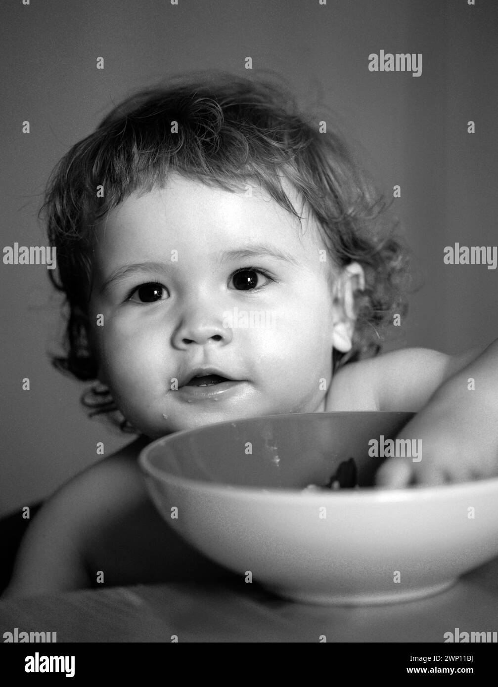 Portrait of cute Caucasian child kid with spoon. Hungry messy baby with ...