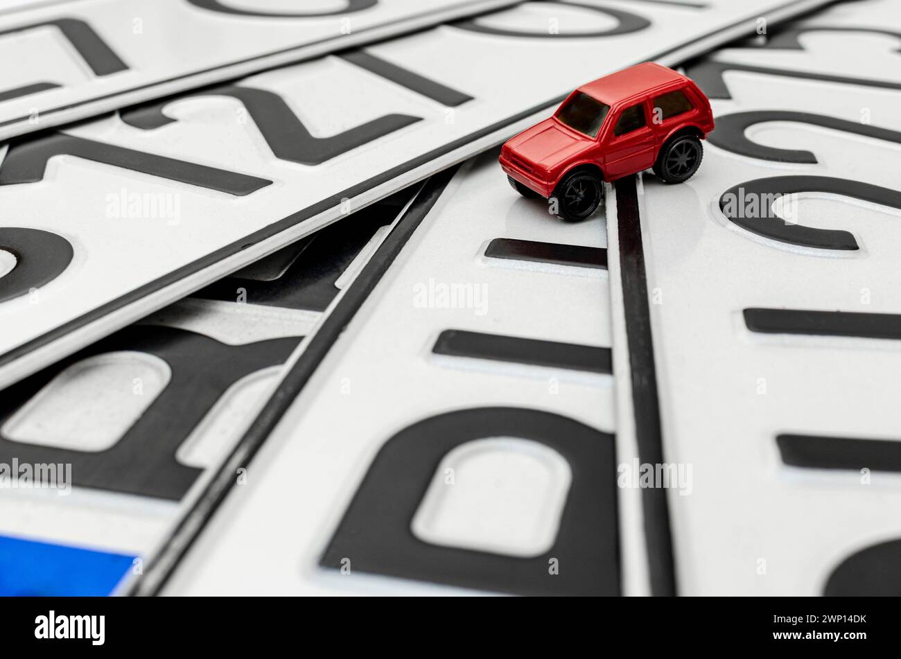 Close-up of car license plates with a toy car, the concept of buying ...