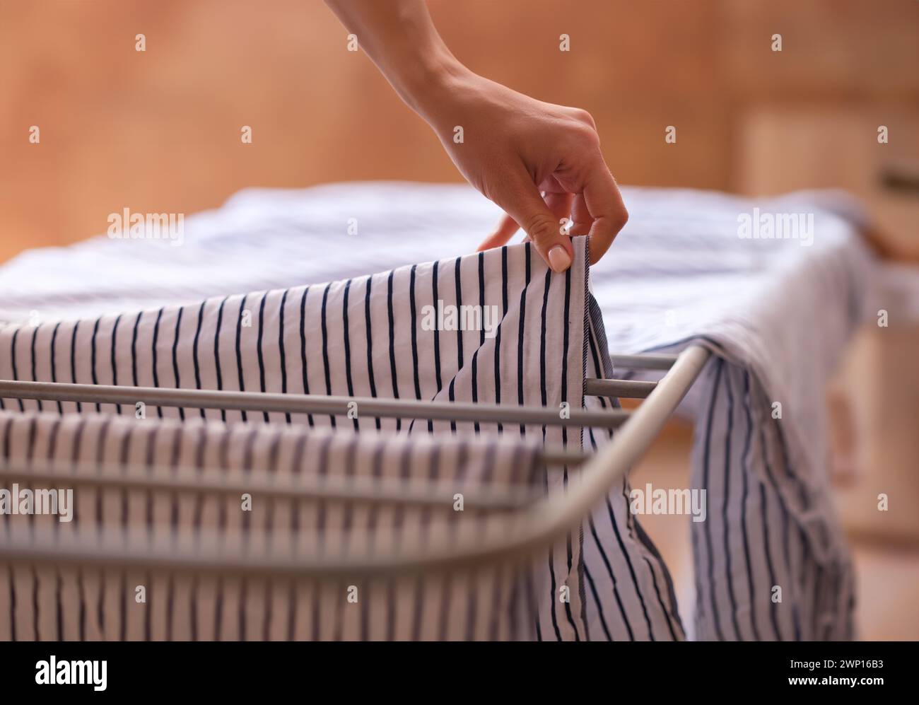 Woman hangs clean linen on clothes dryer after washing closeup Stock ...