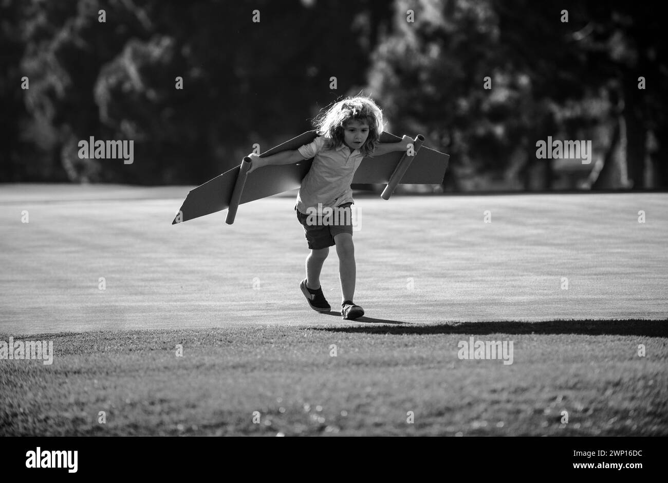 Child to be pilot. Kid with paper wings flying. Summer vacation and ...