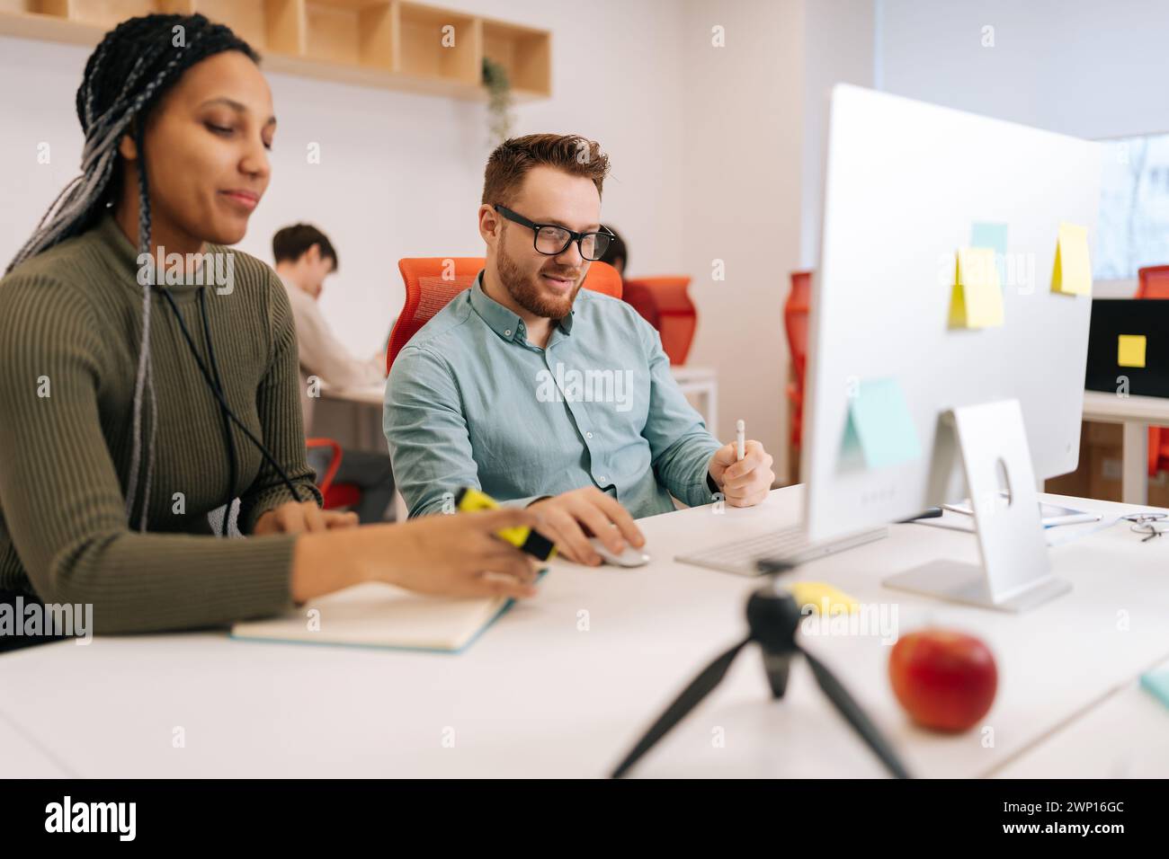 Portrait of male teacher, manager or mentor helping African-American ...