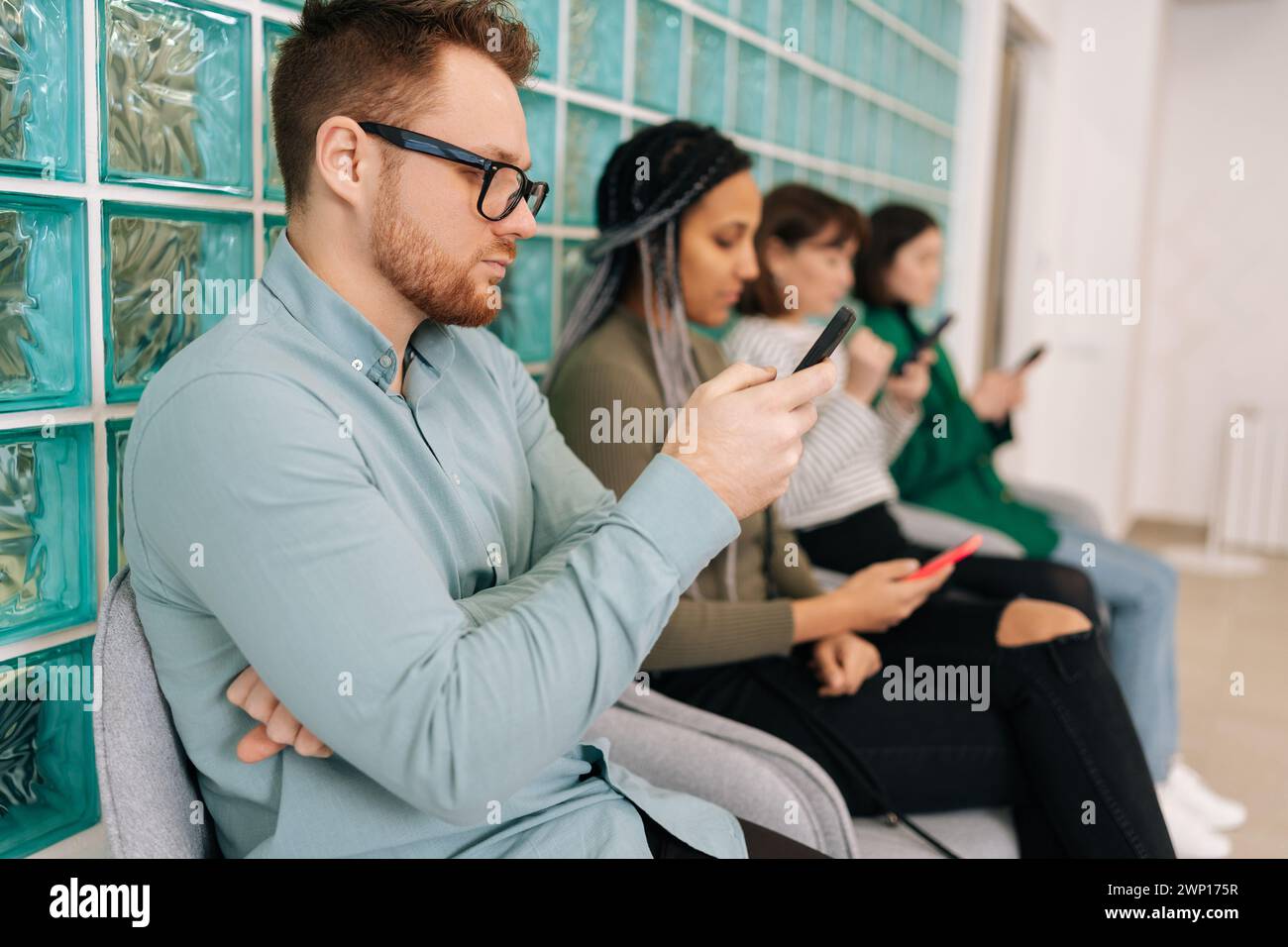 Side view of focused young diverse ethnicity candidates using mobile ...