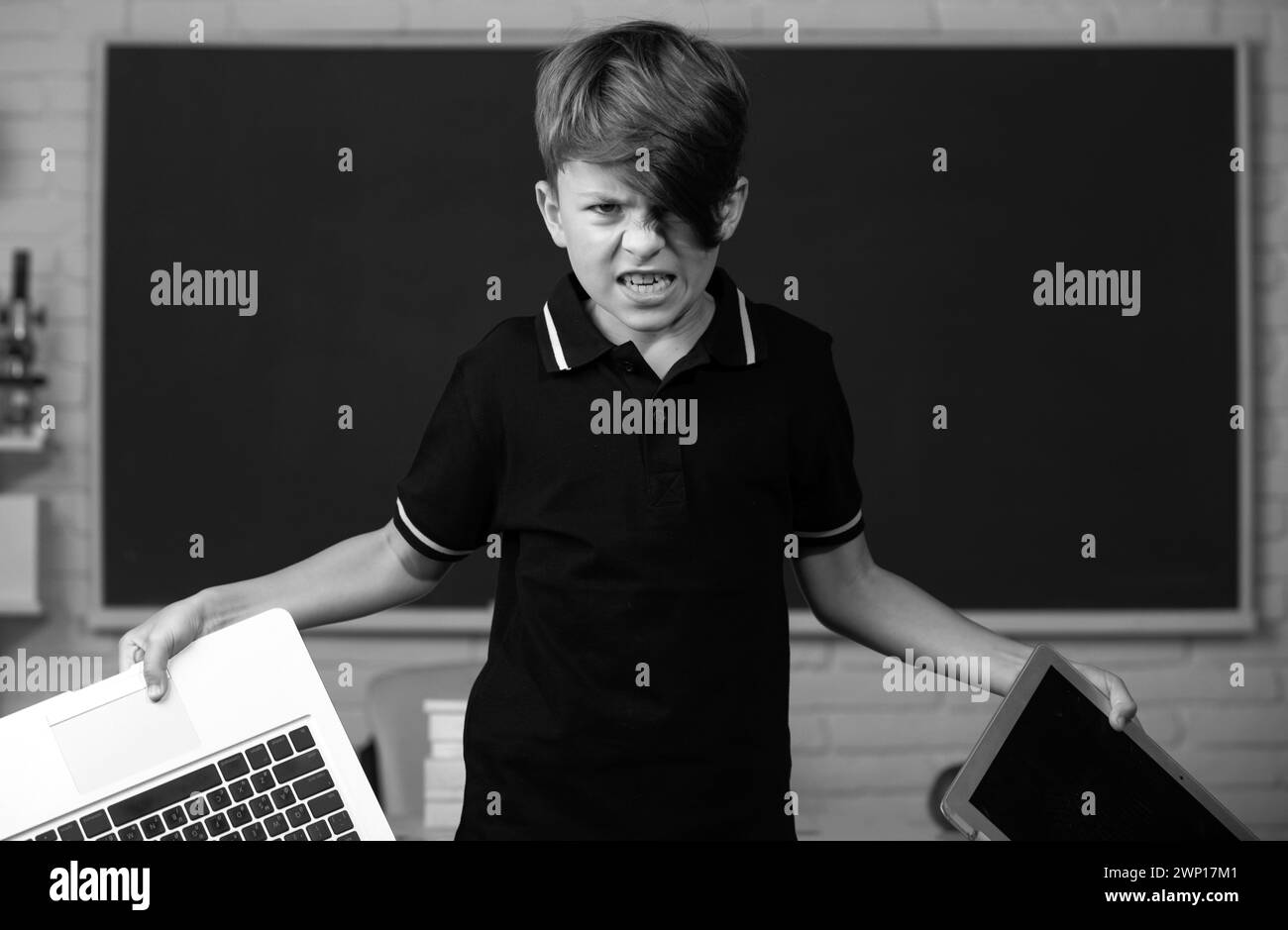 Angry boy in opposition distance education. School kid broken online ...