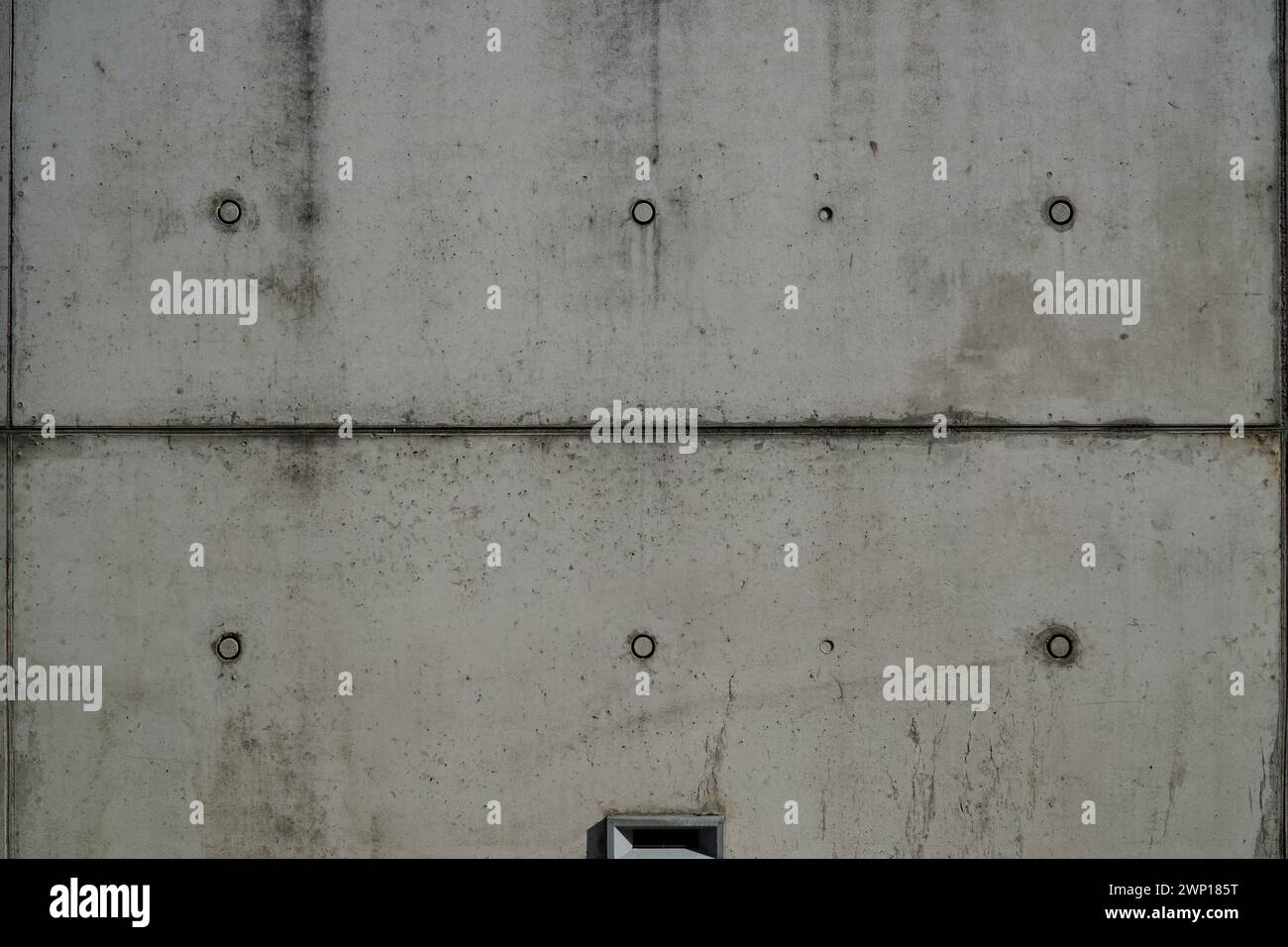 Concrete wall with round wholes Stock Photo - Alamy