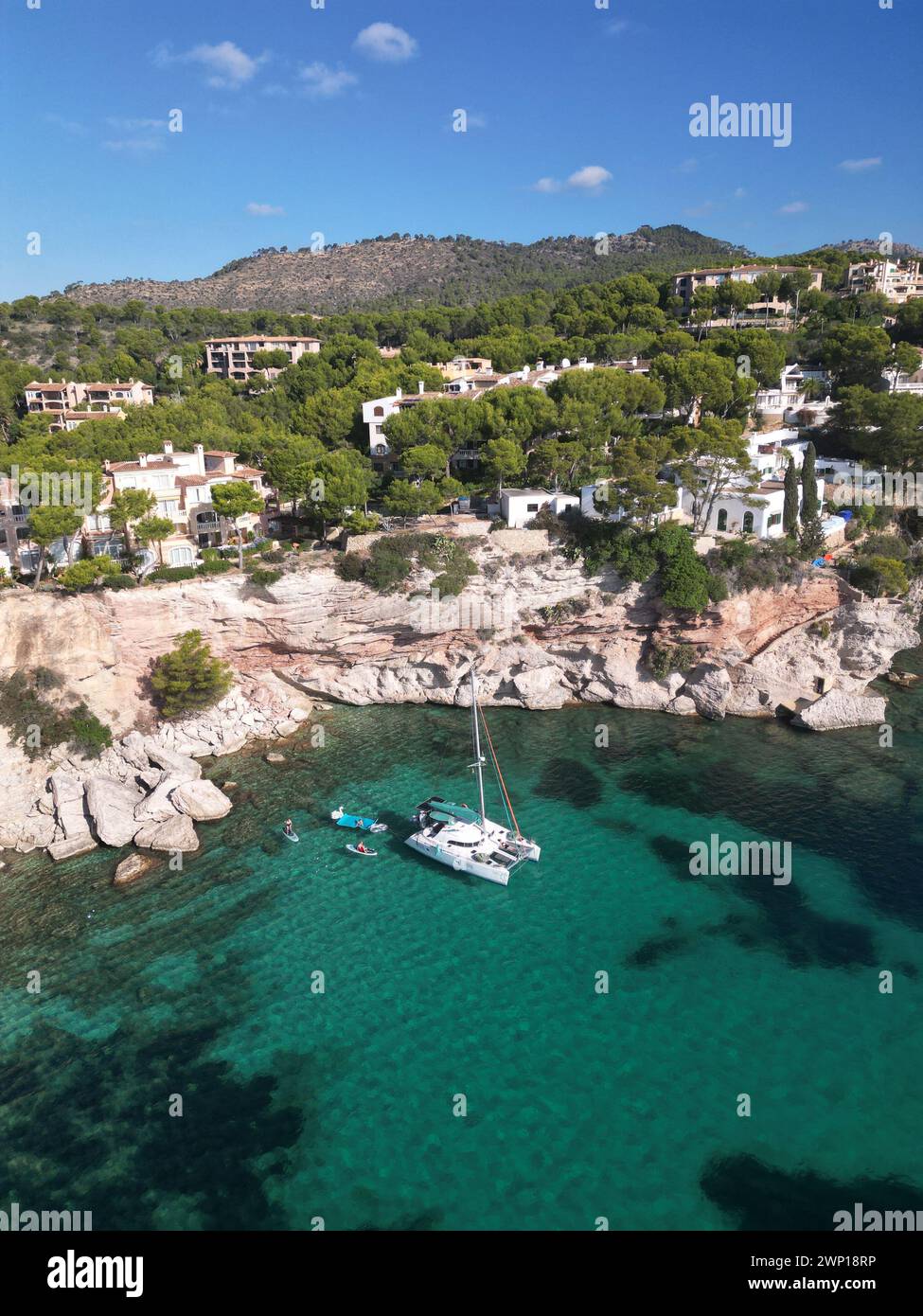 Sailing Catamaran anchoring in beautiful Mallorcan bay in turquoise ...