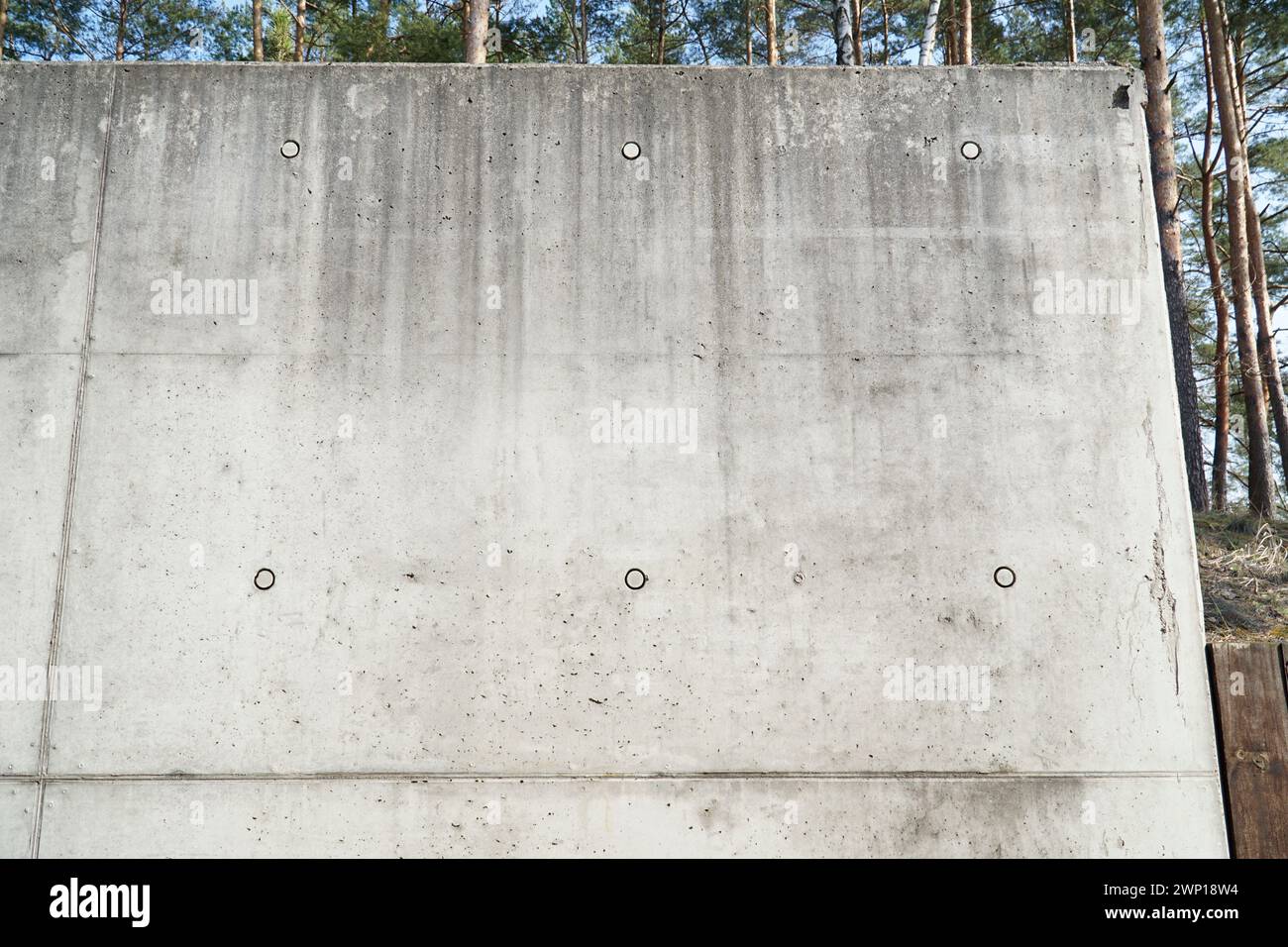 Concrete wall with round wholes Stock Photo - Alamy