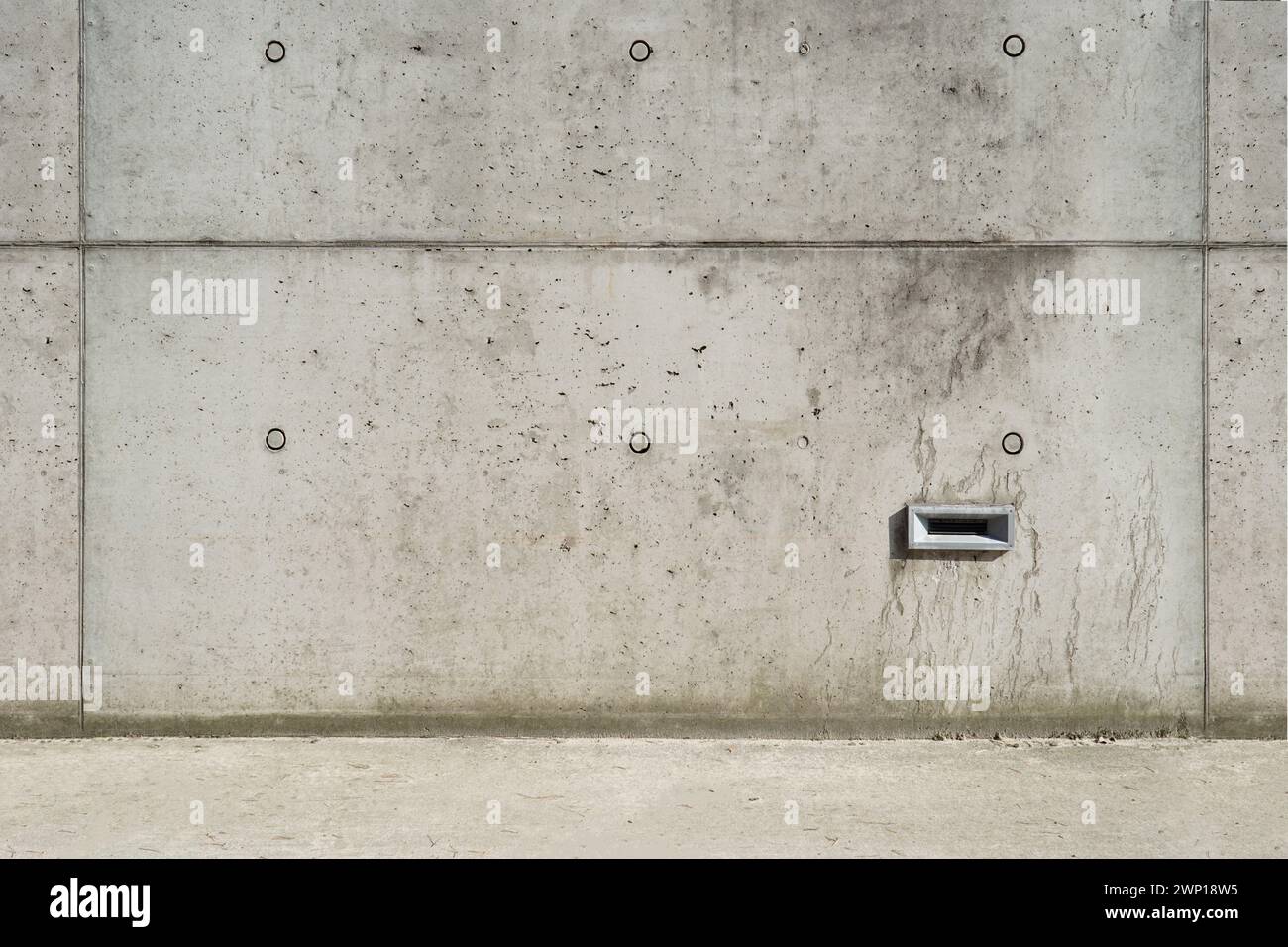 Concrete wall with round wholes Stock Photo - Alamy