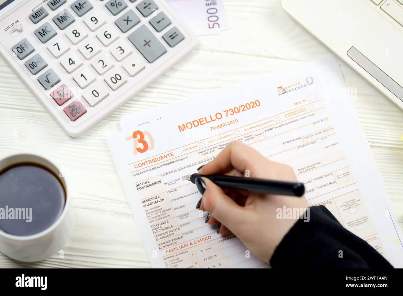 KYIV, UKRAINE - OCTOBER 31, 2023 Accountant fill italian tax form ...