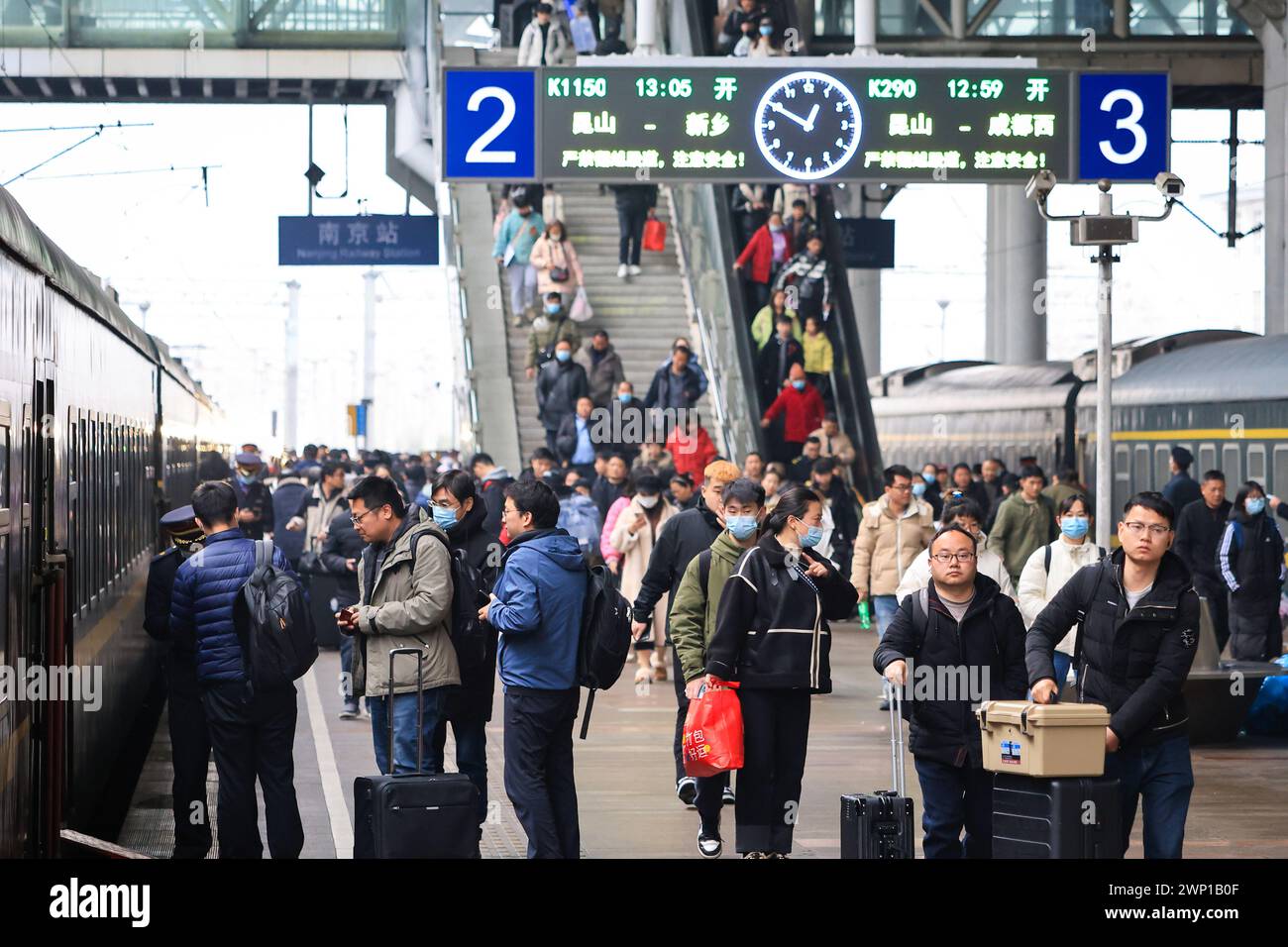 Beijing, China's Jiangsu Province. 5th Mar, 2024. Passengers prepare to board a train in Nanjing ...