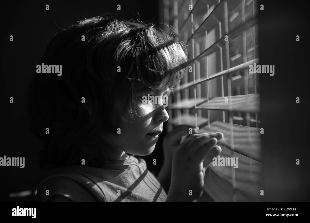 Coronavirus pandemic. Child looking through window. Qarantine concept ...