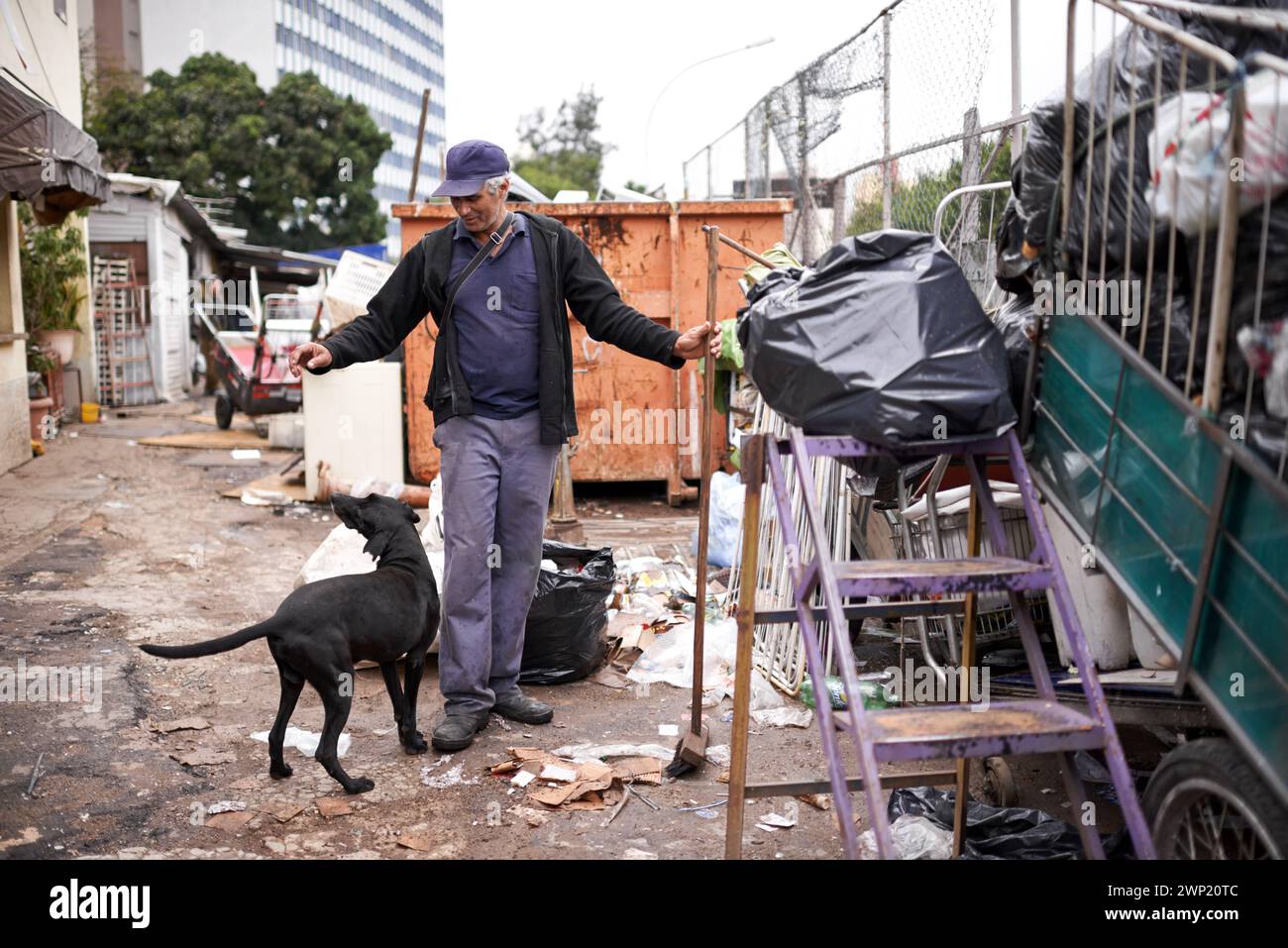 Man, worker and cleaning of trash for waste management in junkyard with ...