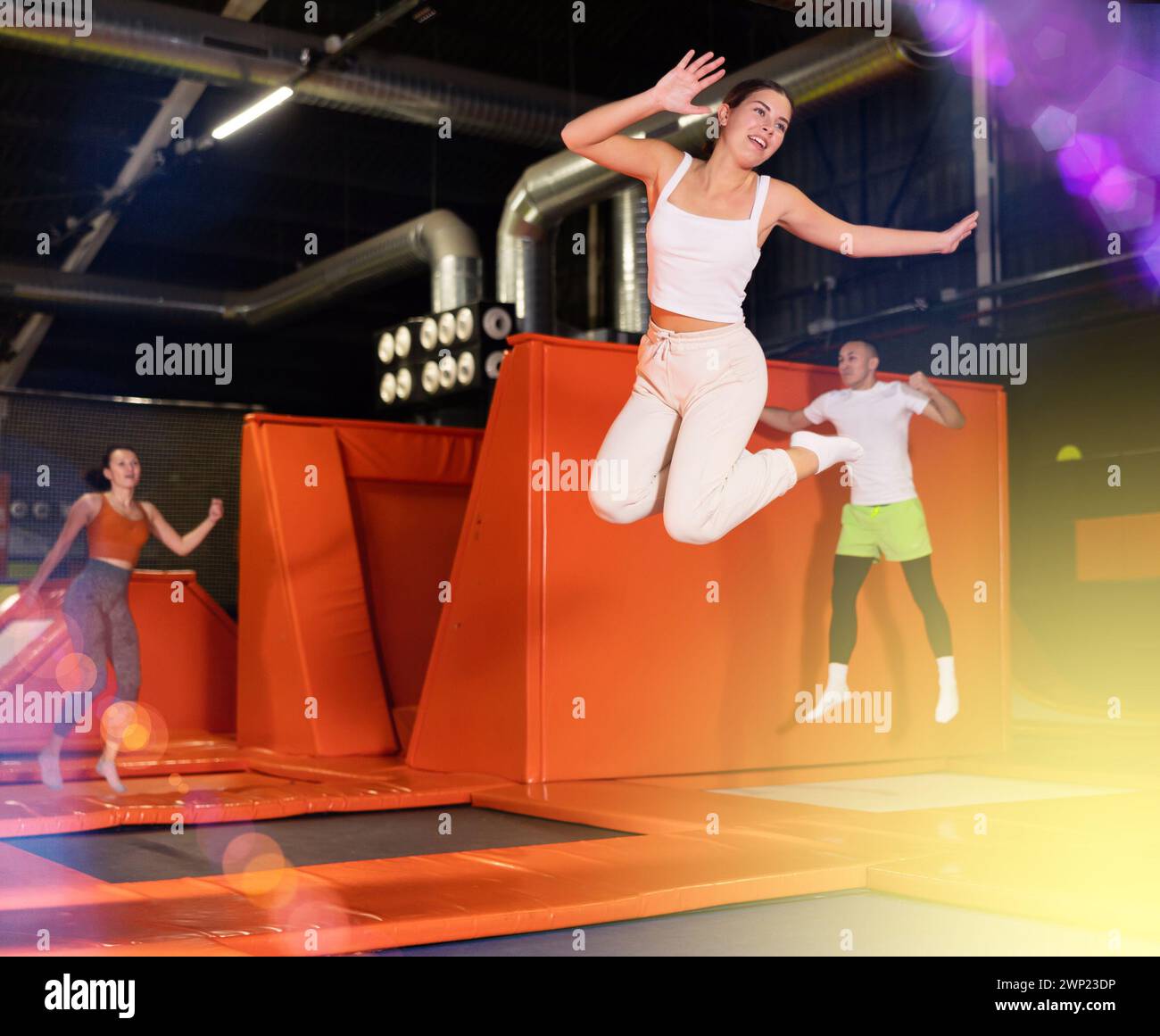 Excited young girl jumping at indoor trampoline center Stock Photo - Alamy