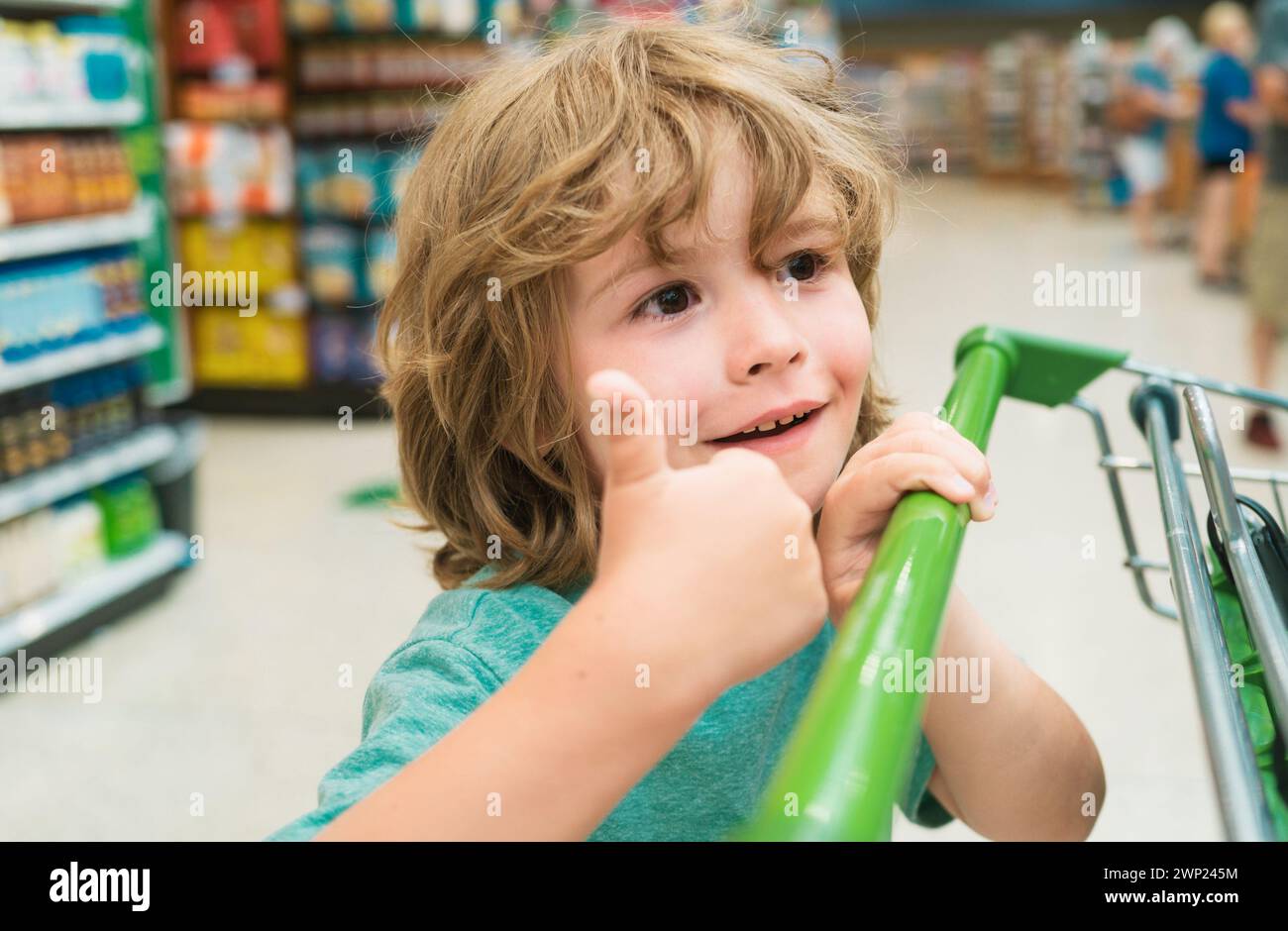 Child in supermarket. Boy with a grocery cart Stock Photo - Alamy