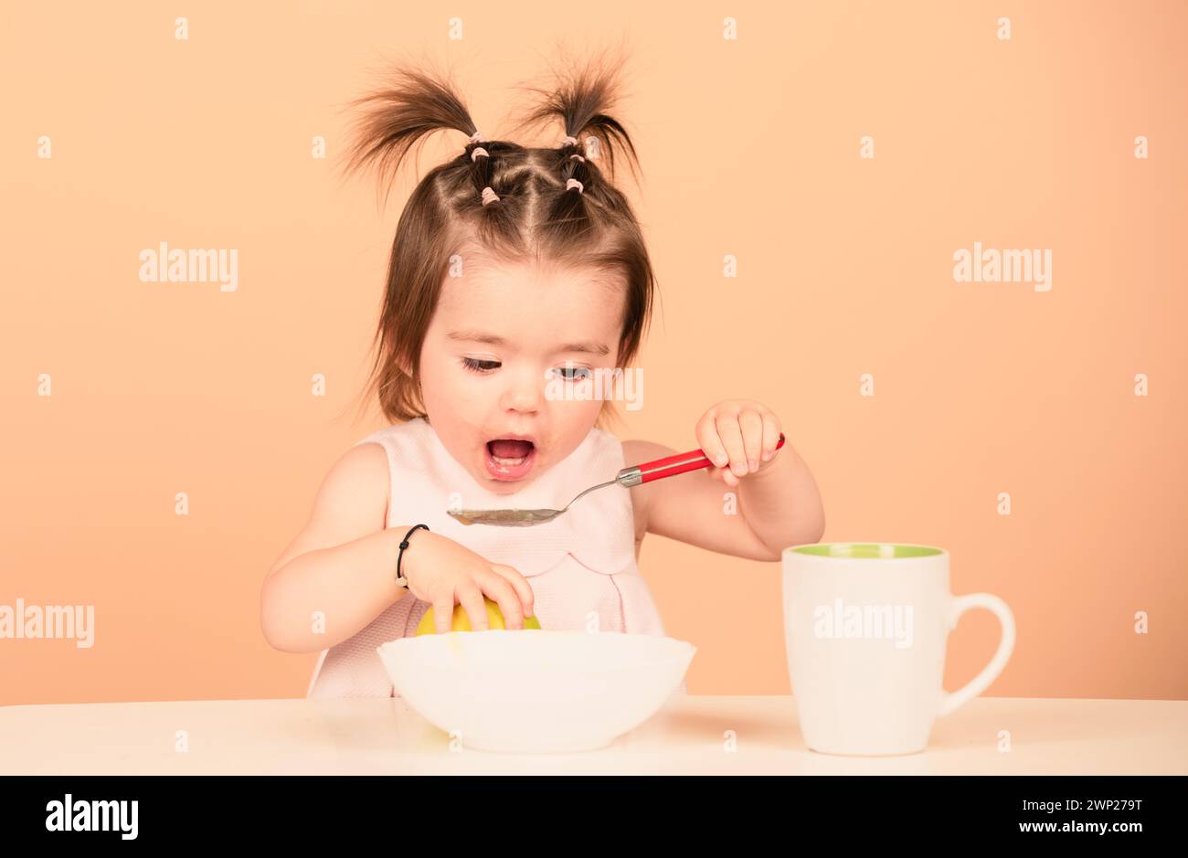 Cute baby child eat food, babies eating. Little baby eating fruit puree ...