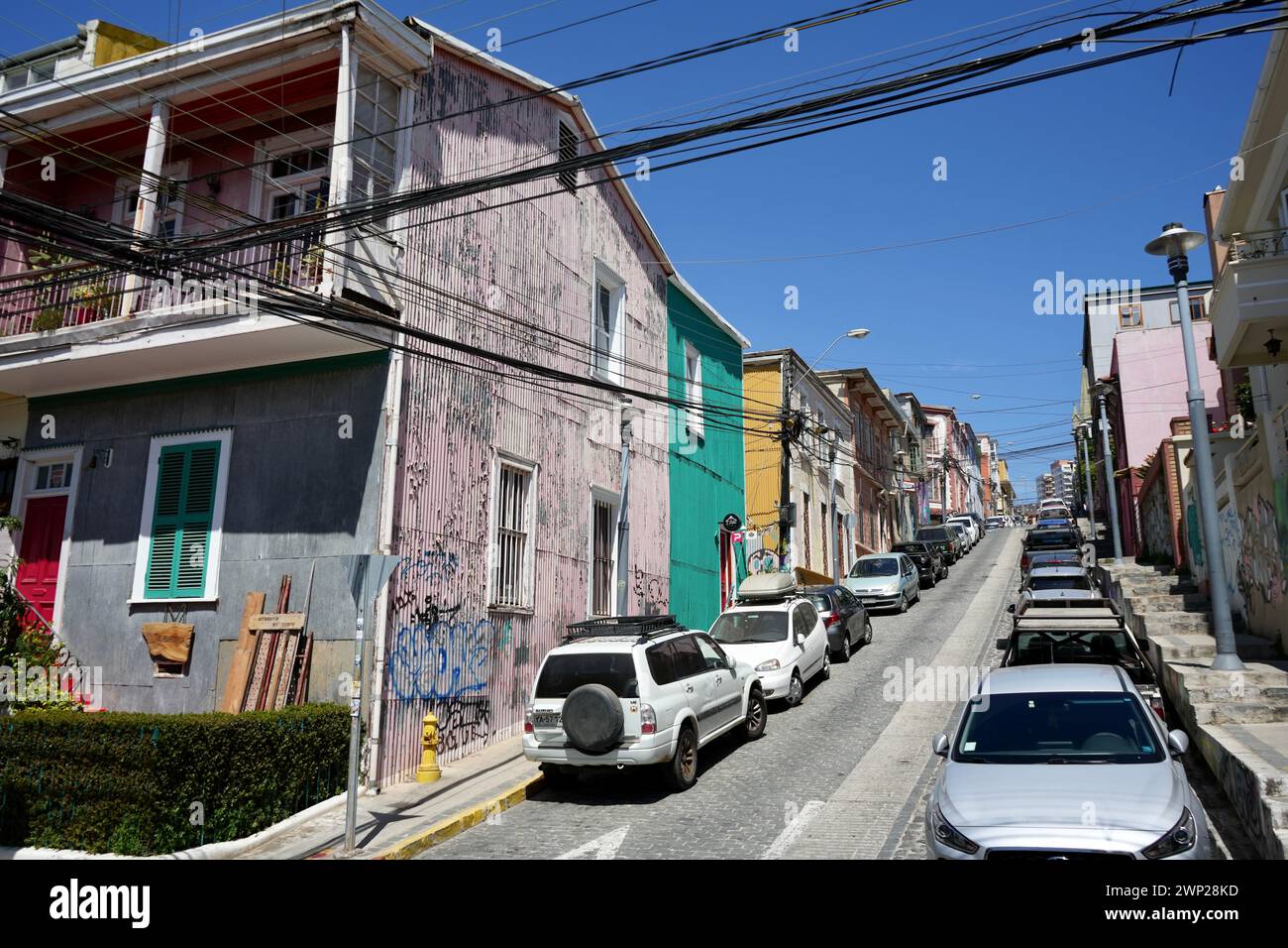 Steep street with colorfully painted houses Stock Photo - Alamy