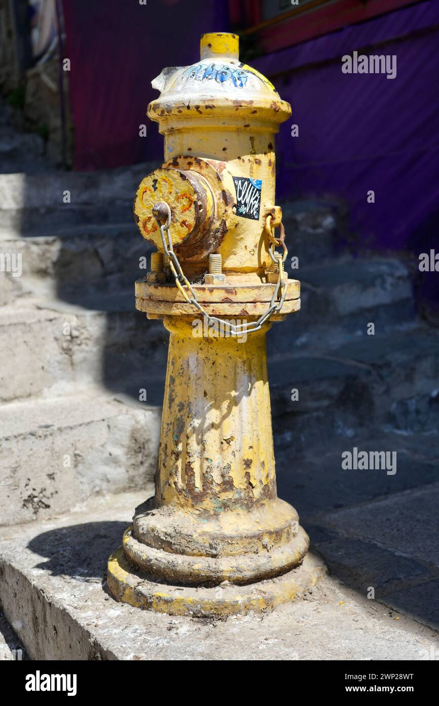 Rustic yellow fire hydrant in the sunshine with steps behind Stock ...