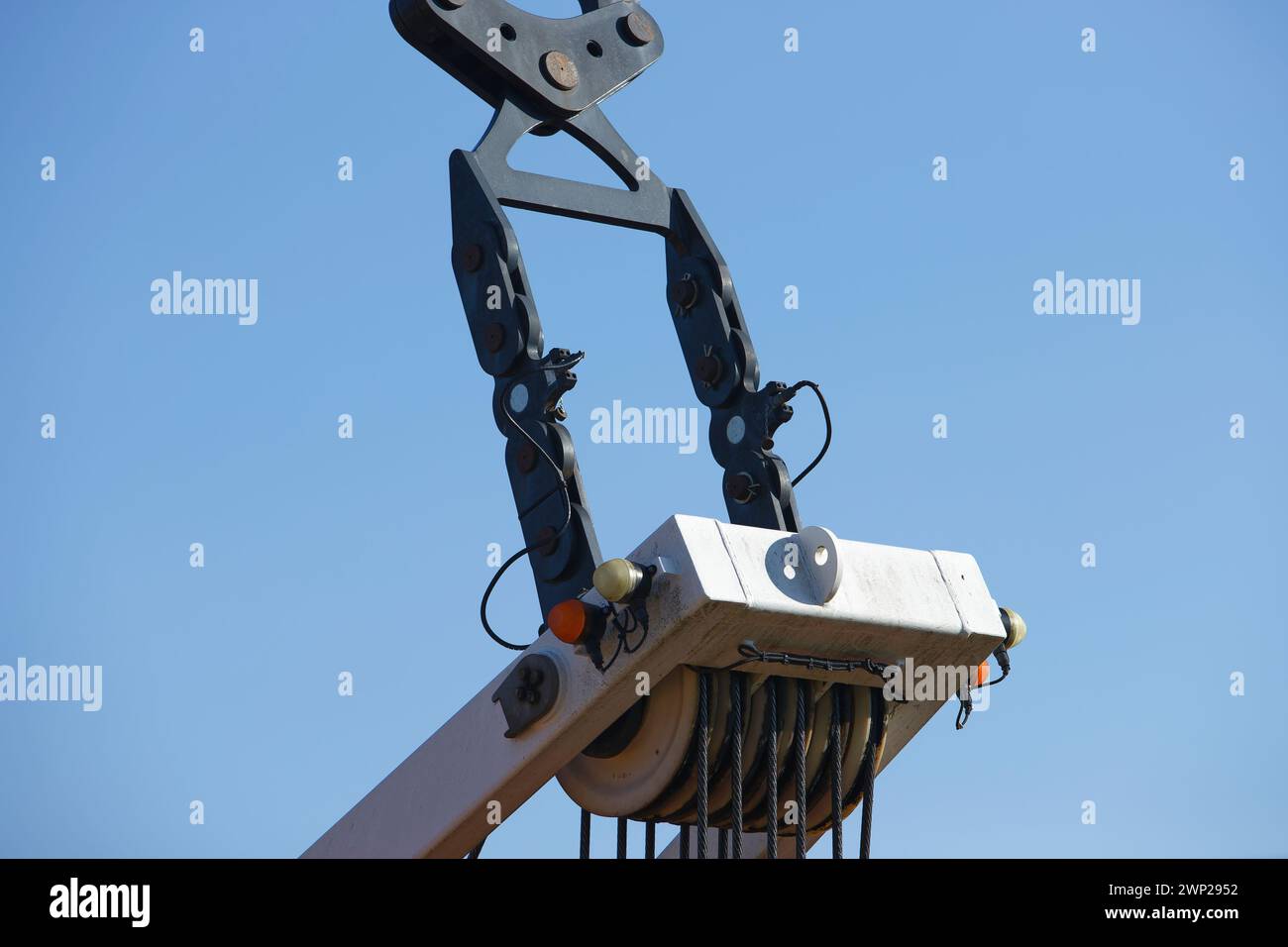 Mobile crane close up of wire ropes and pulley block with steel ...