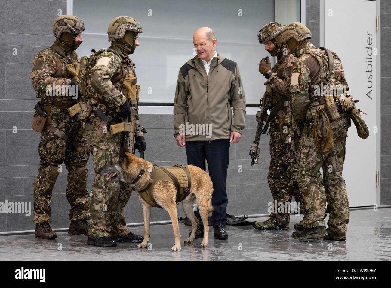 German Chancellor Olaf Scholz, center, talks to soldiers during a visit ...