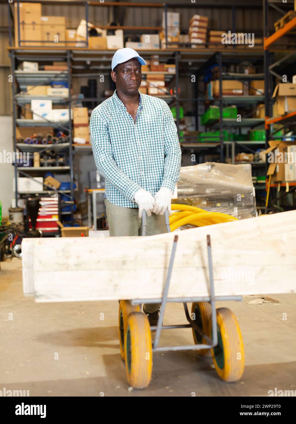 African-american man carrying trolley with building materials Stock ...
