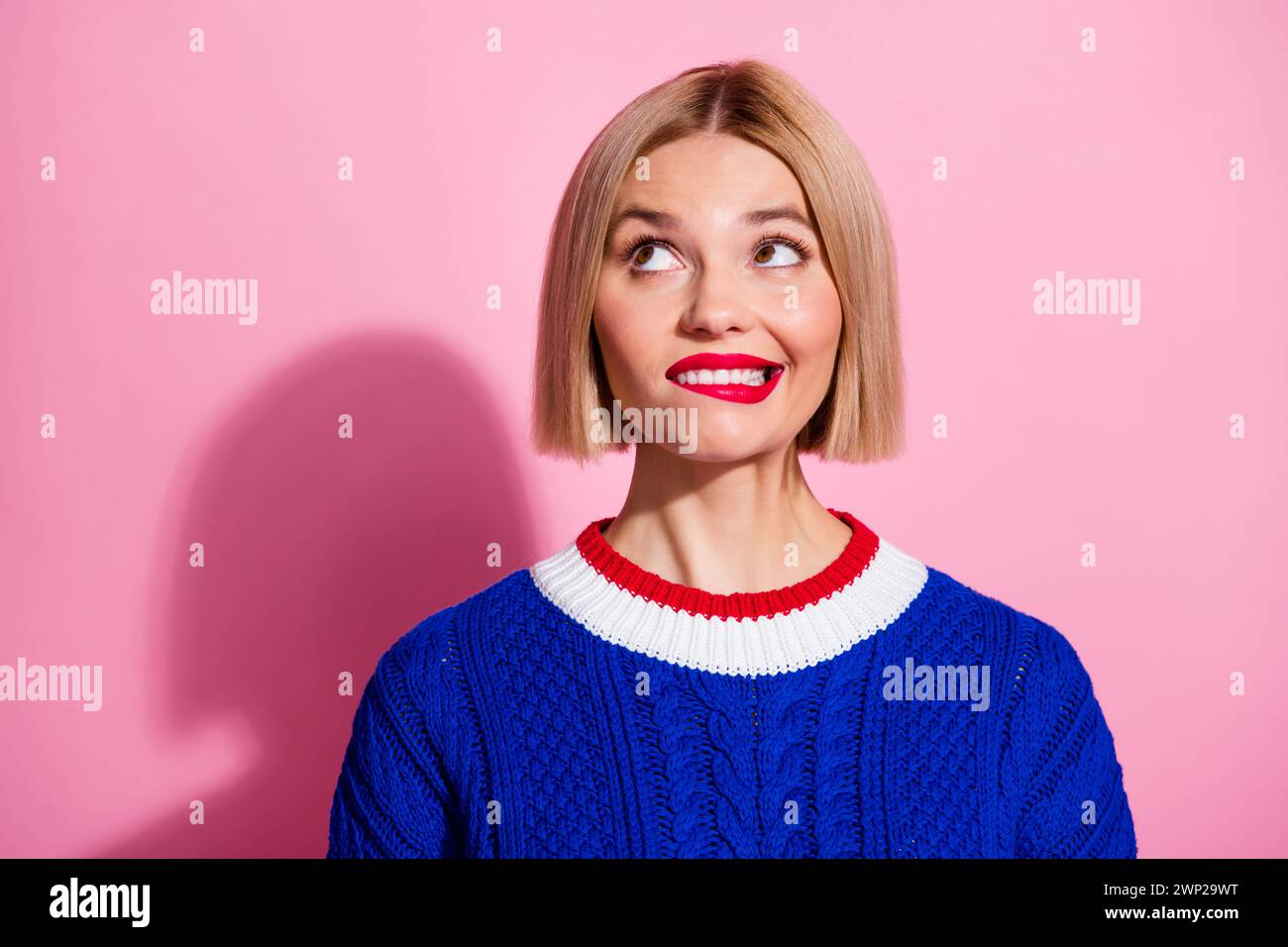 Photo Portrait Of Lovely Young Lady Look Interested Empty Space Bite Lips Dressed Stylish Blue