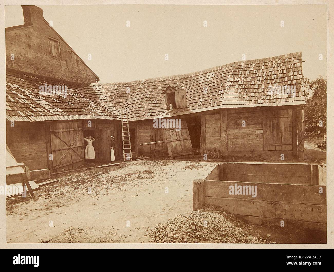 Photograph of wooden economic buildings in a village, captured between ...