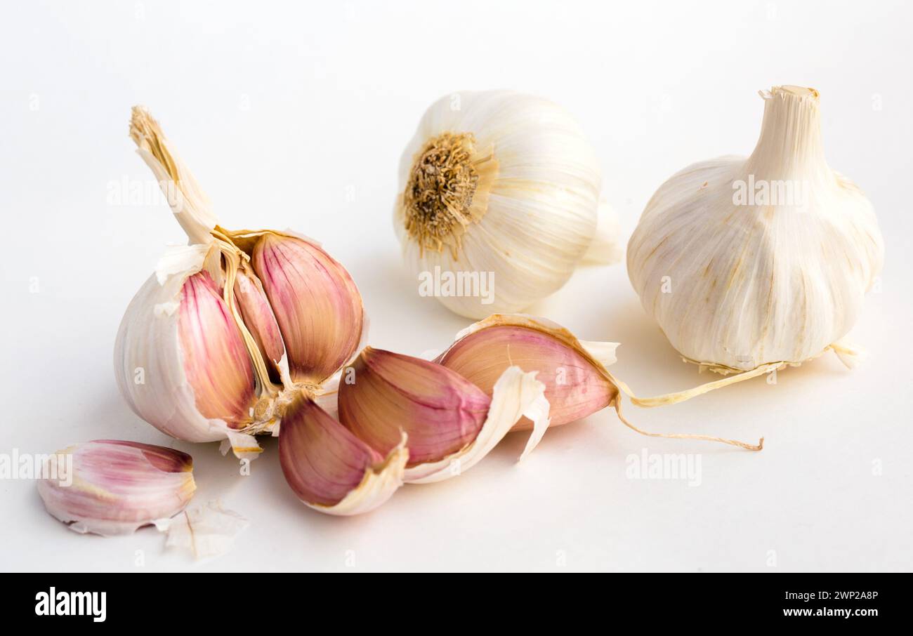 Fragrant garlic heads and cloves on white background Stock Photo - Alamy