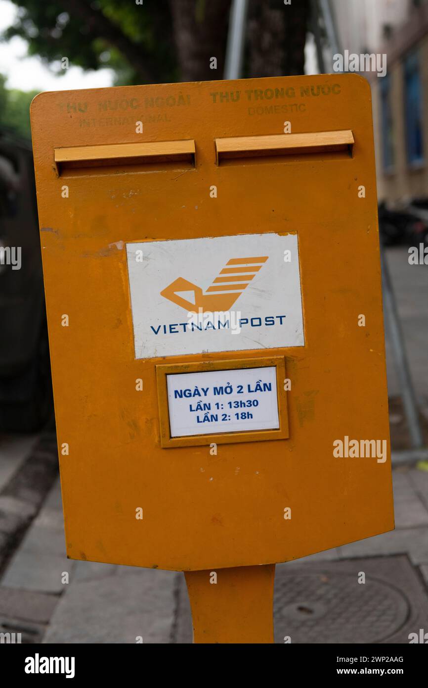 Yellow letter collection box of the Vietnam Post with the hours of ...