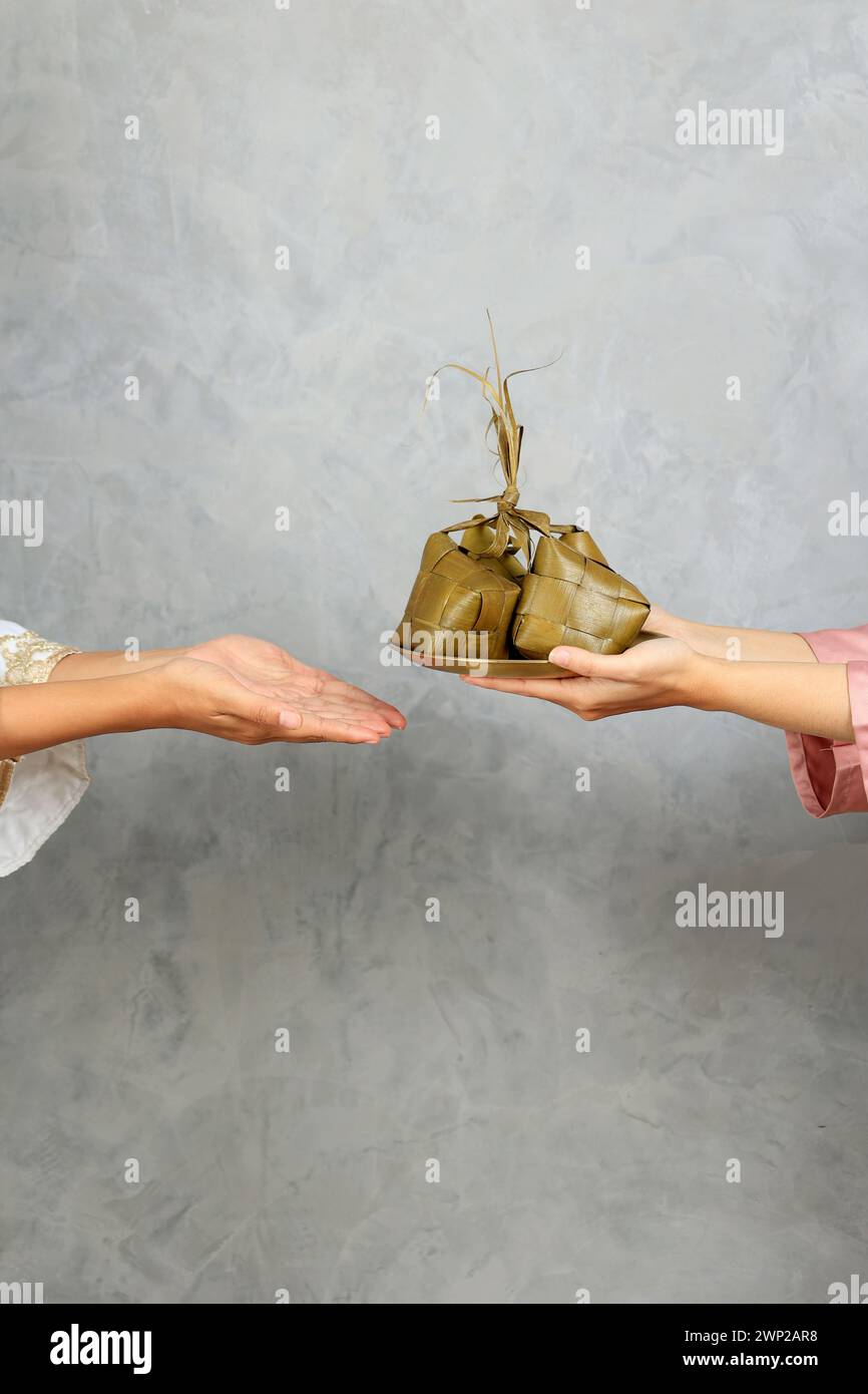 Sharing Ketupat, Two Female Sharing Diamond Shape Rice Cake for Eid al ...