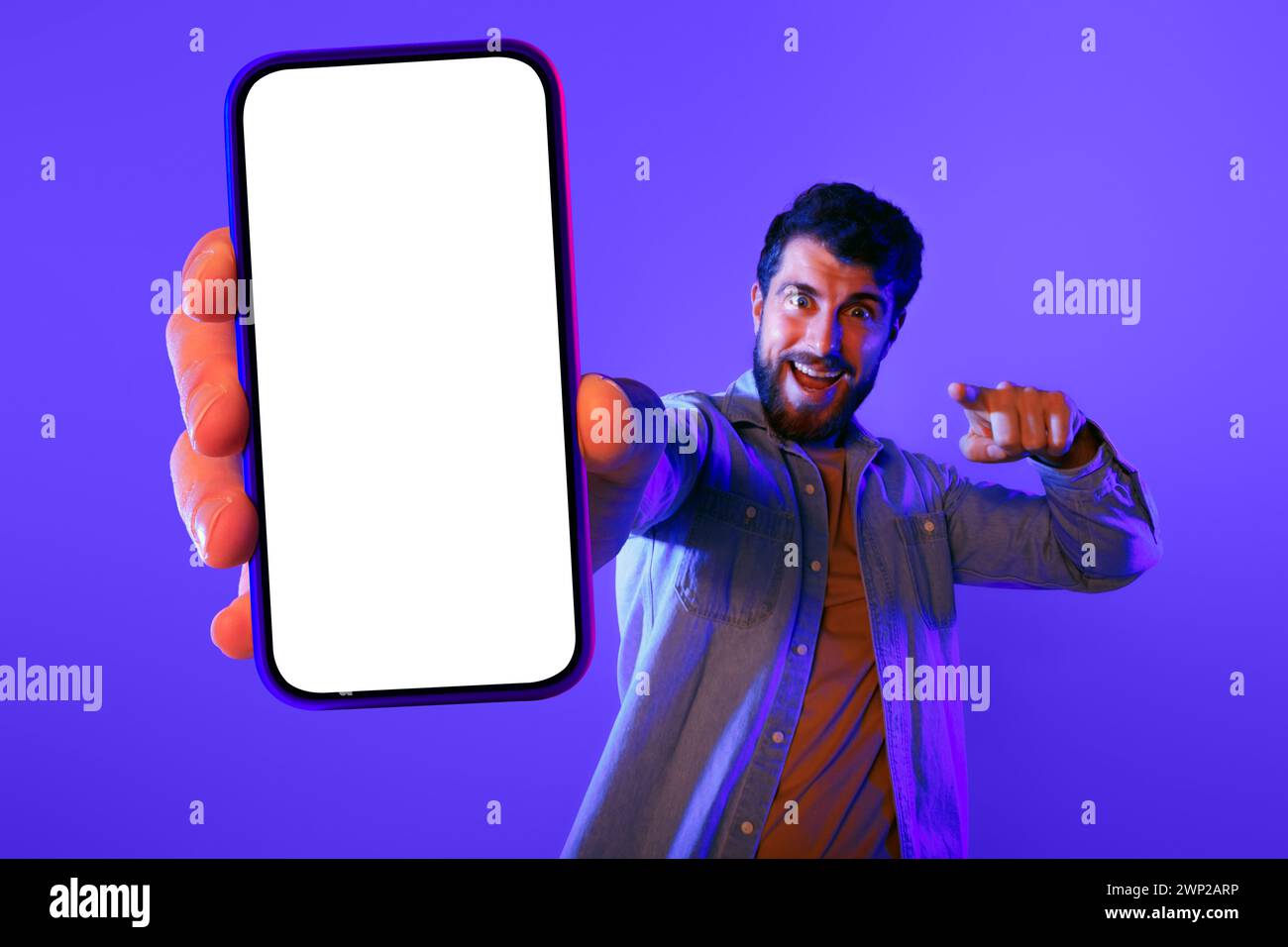 guy pointing to camera showing blank screen of smartphone, studio Stock ...