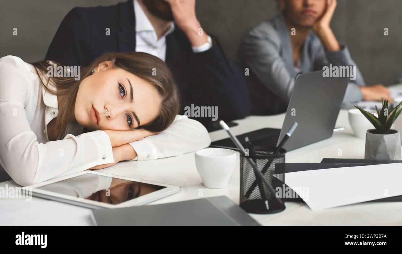 Boring presentation. Young business people looking bored Stock Photo ...