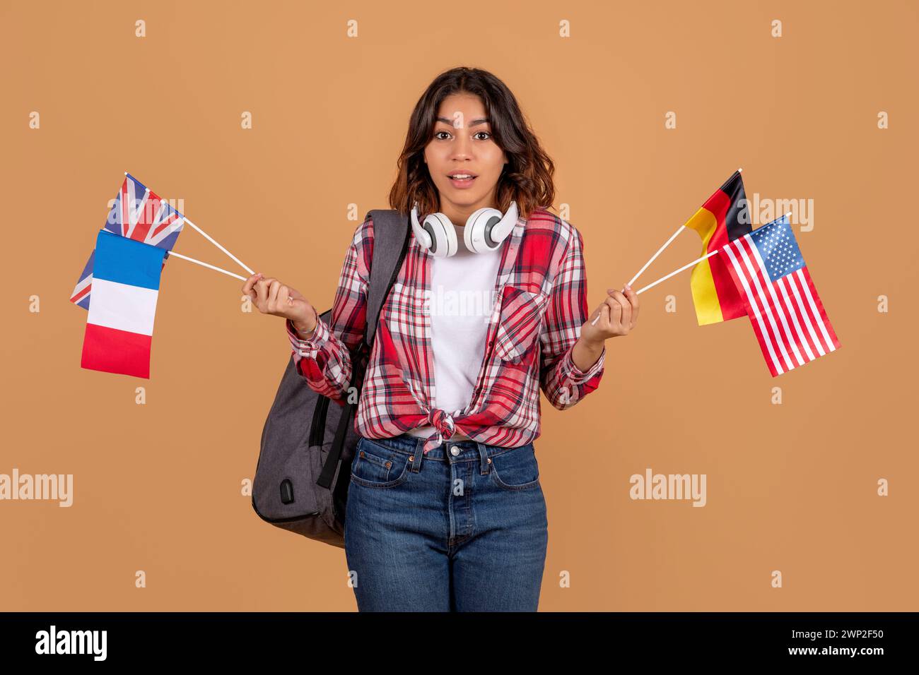 Confused middle eastern woman student holding bunch of flags Stock ...
