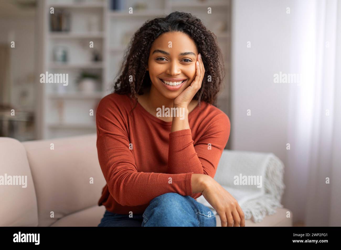Portrait of attractive black woman with captivating smile sitting ...