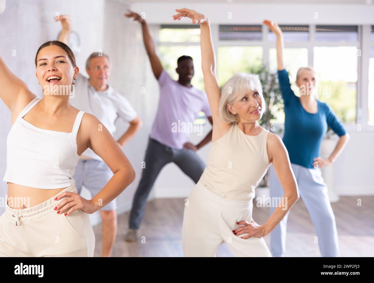 Female instructor teaches senior students of different ages basic ...