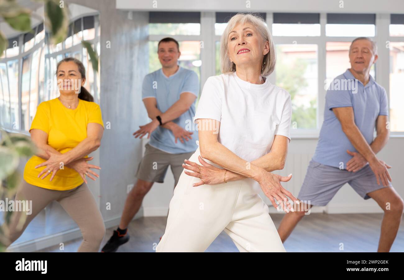 Elderly woman dances modern dances in group Stock Photo - Alamy