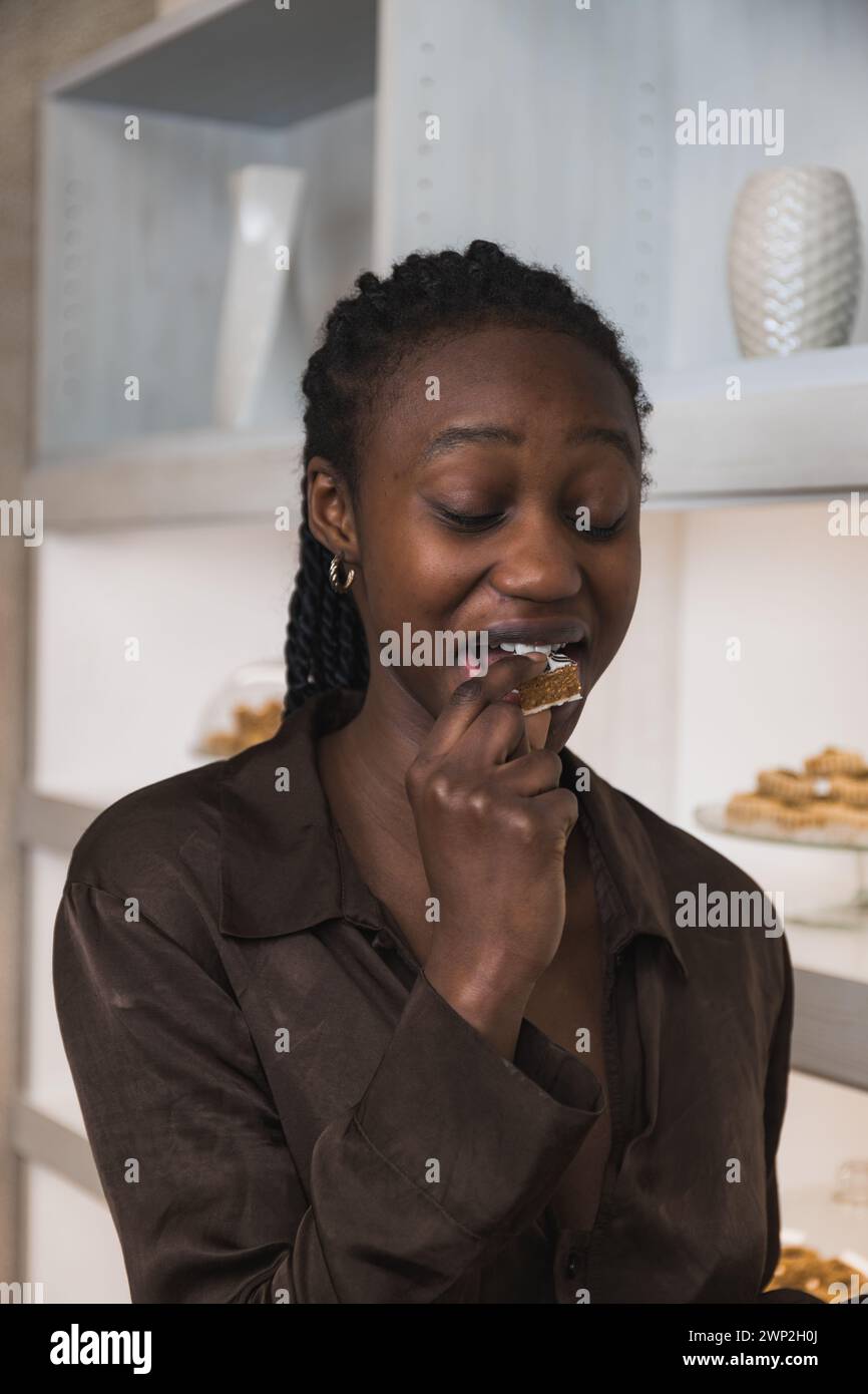 Vertical photo a customer african is captured mid-bite enjoying a piece ...