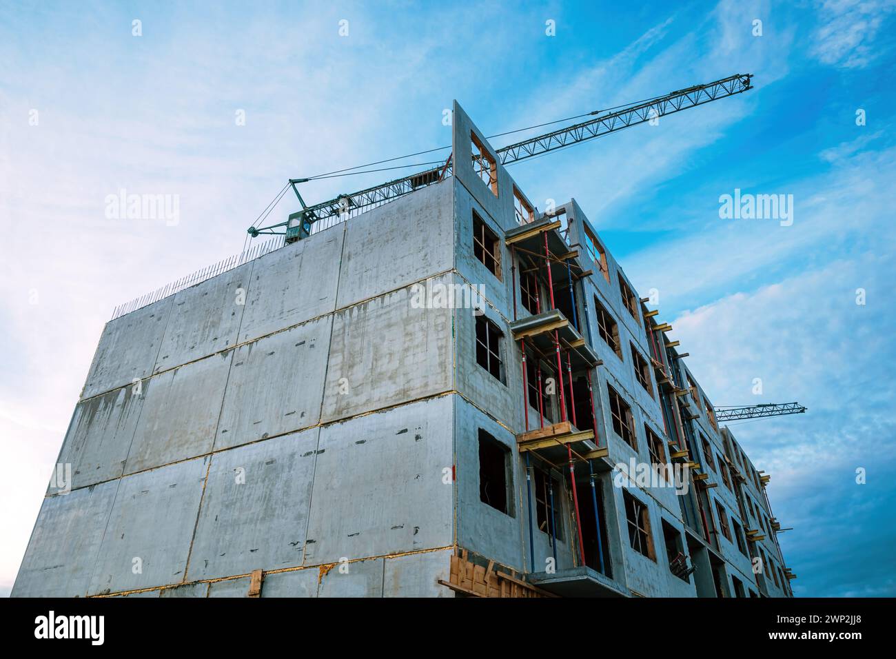 Tall prefabricated residential building construction site with old ...