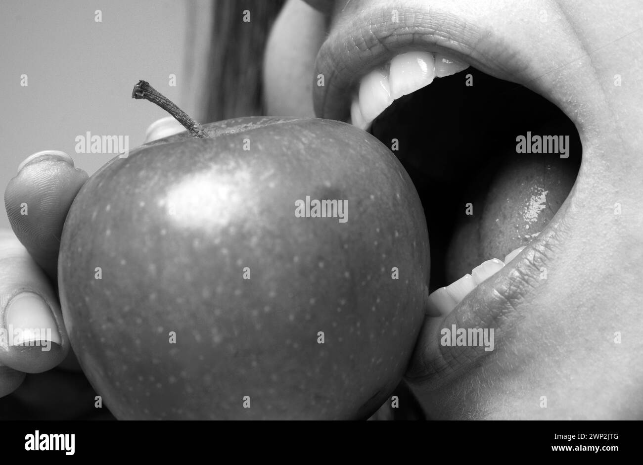 Mouth eating apple Black and White Stock Photos & Images - Alamy