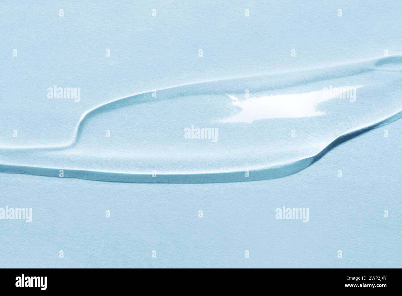 The smear of a transparent gel on a blue background. The texture of the ...