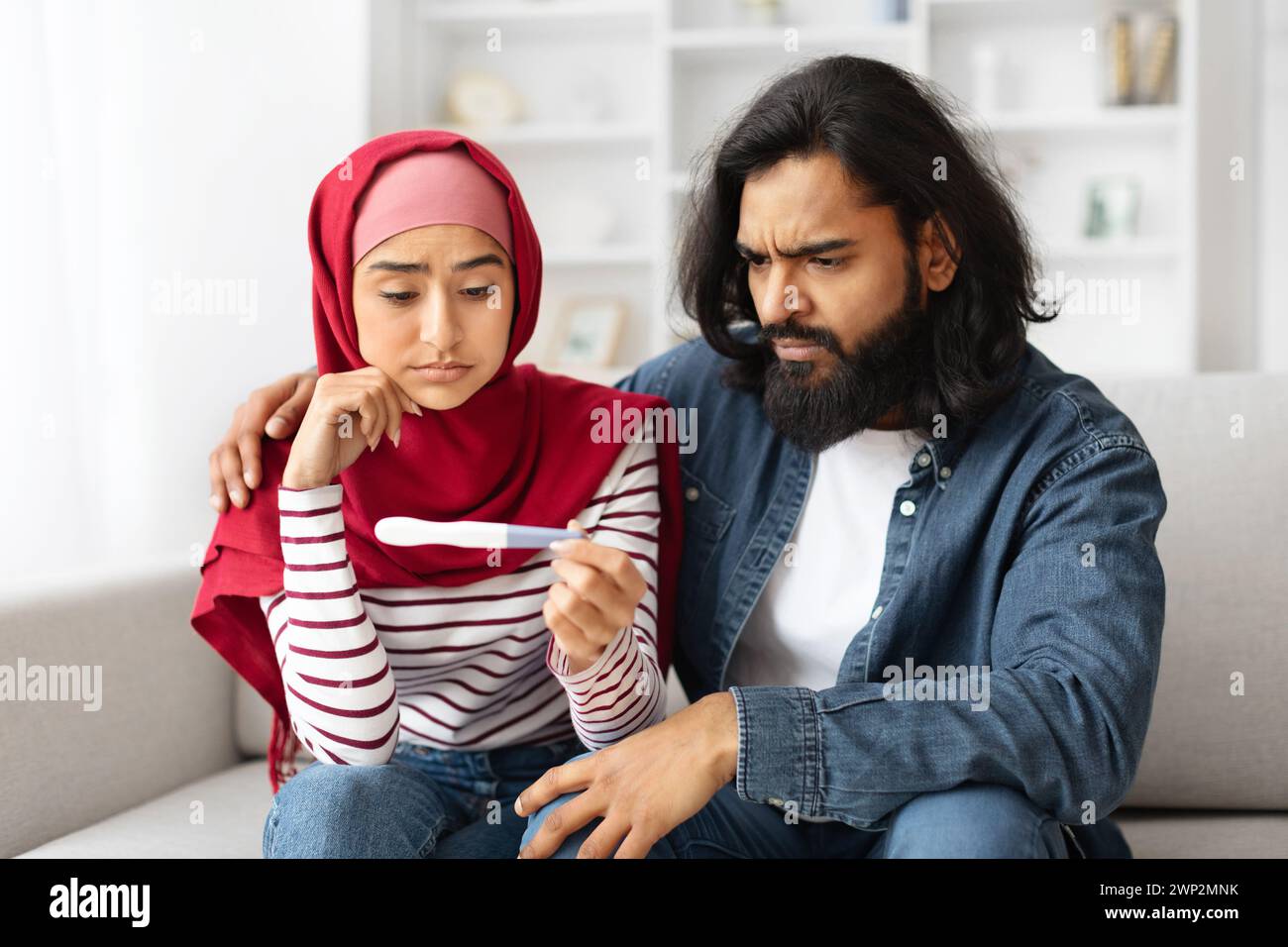 Infertility Problems. Upset Young Muslim Couple Looking At Negative ...