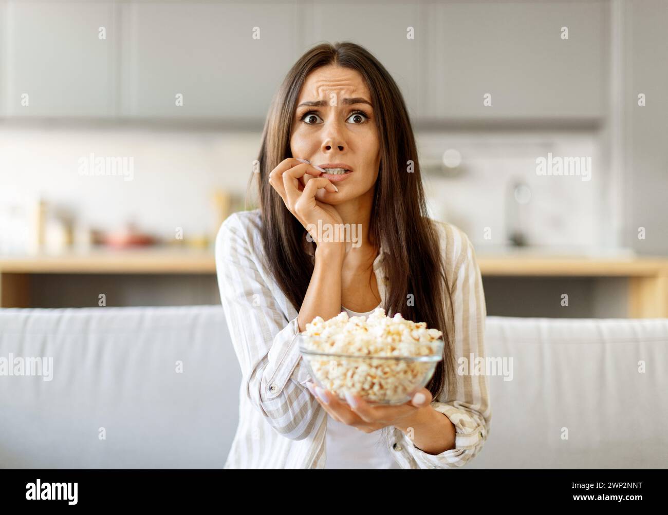 Shock Content. Scared Young Woman Watching Tv And Eating Popcorn At ...