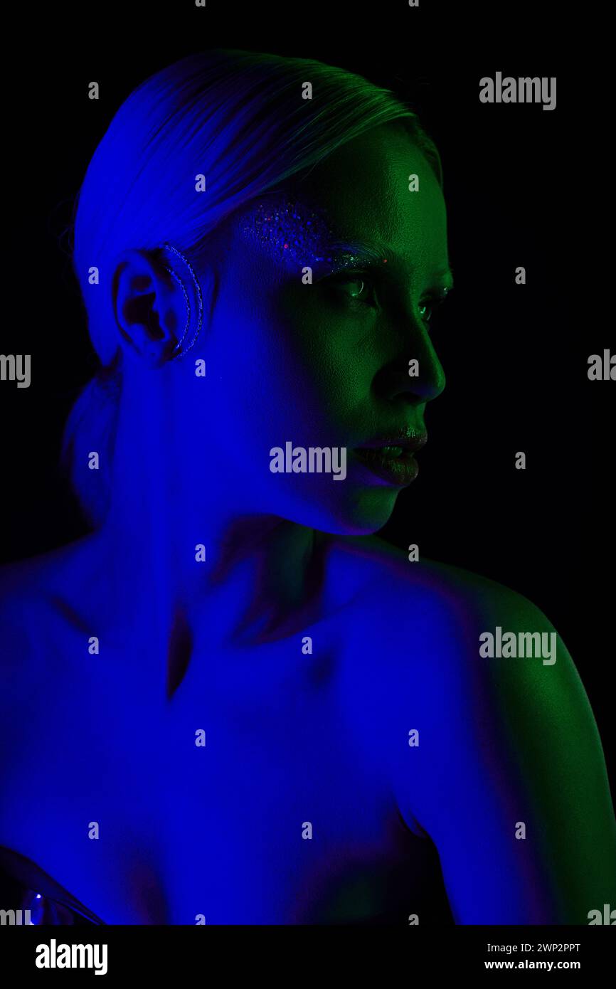 beautiful futuristic woman in metallic sci fi clothing posing in blue ...