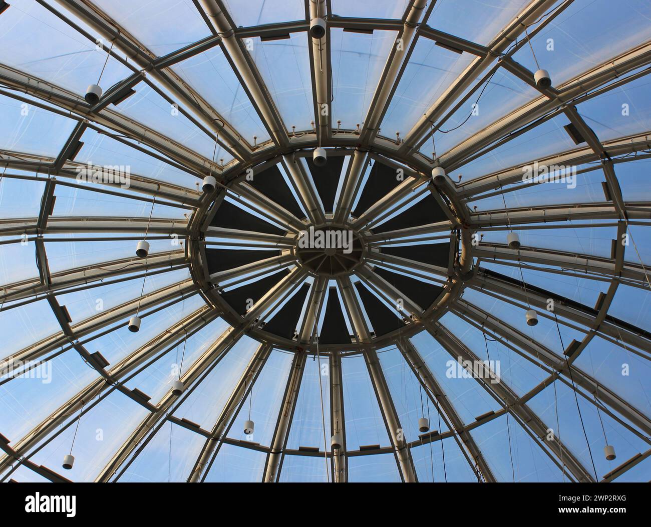 Round glass dome with hanging lighting lamps Stock Photo - Alamy