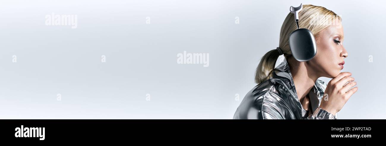 attractive female model with headphones wearing silver robotic attire ...