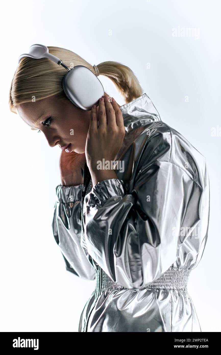 appealing peculiar female model with headphones wearing silver robotic ...