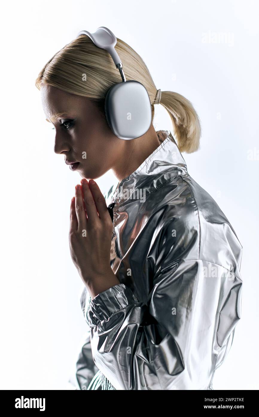 appealing peculiar female model with headphones wearing silver robotic ...