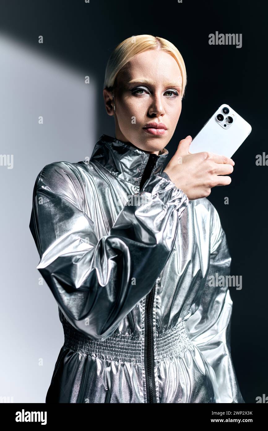 attractive extravagant woman in futuristic silver attire posing with ...