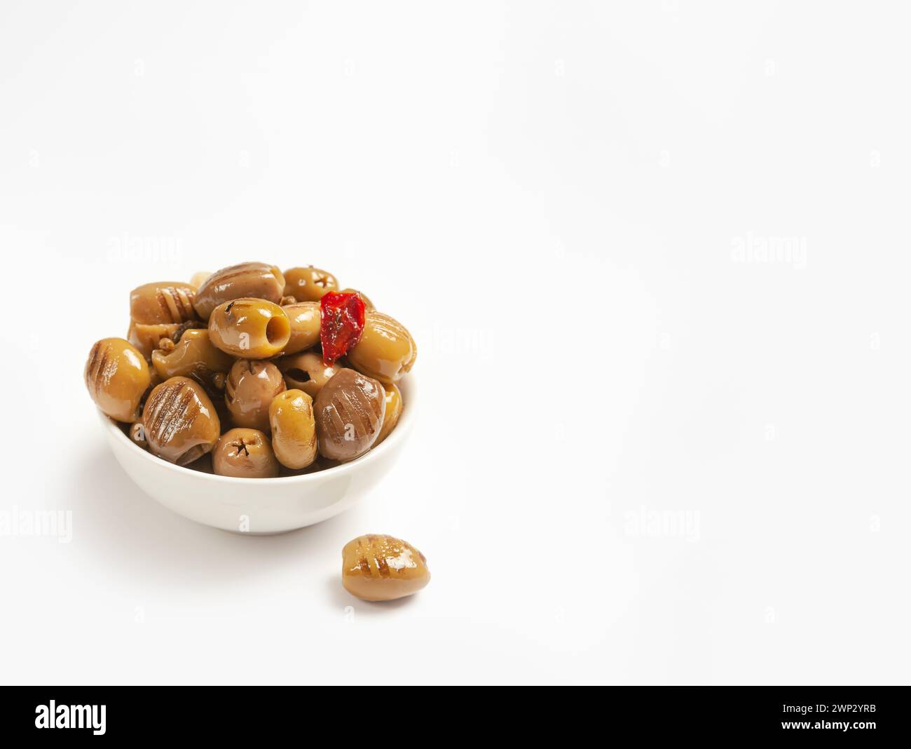 grilled green olives in oil, pitted, with red hot pepper and garlic in ...