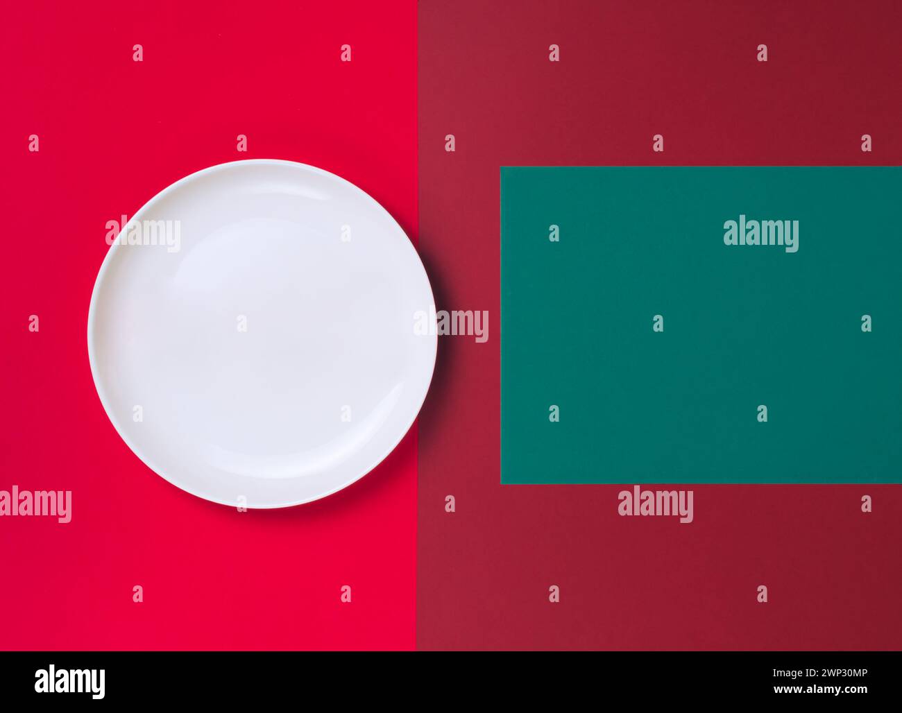 white plate, background from colored paper rectangles of red and green ...