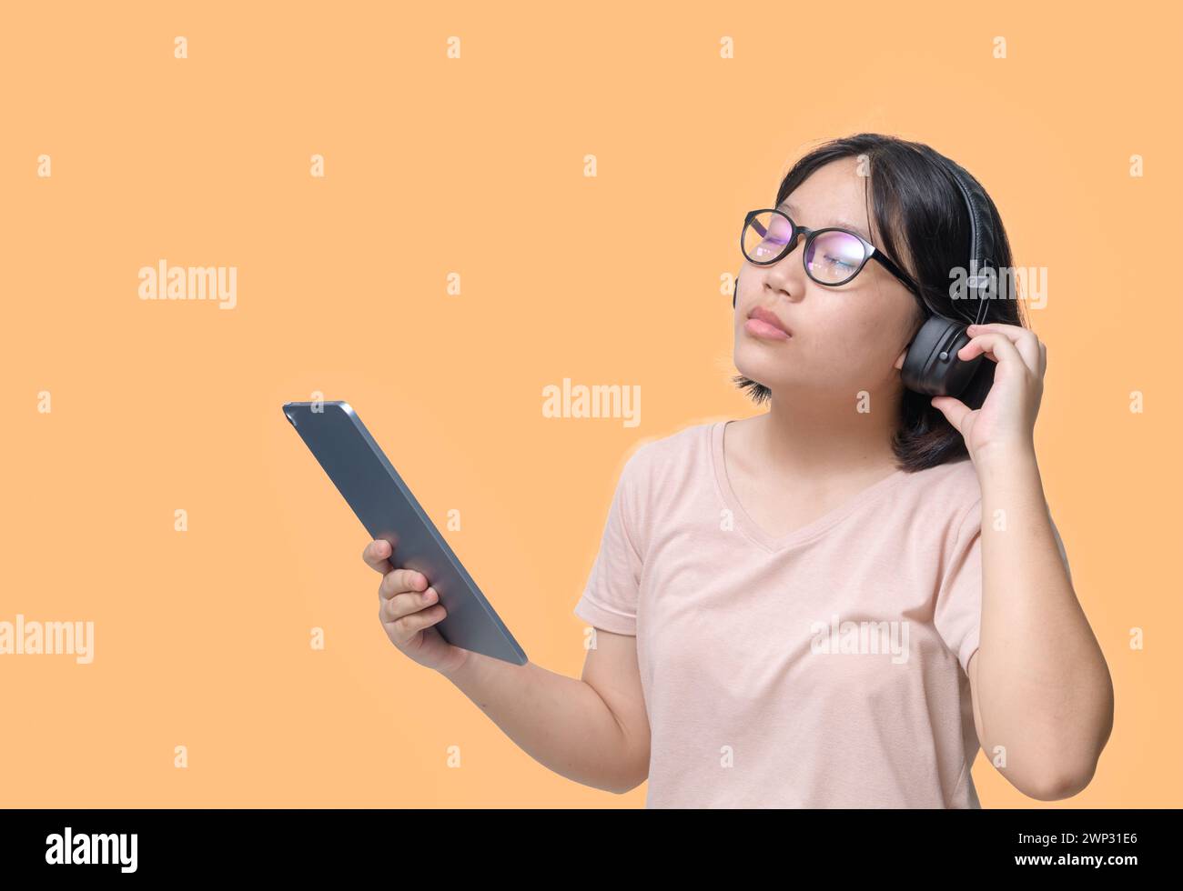 Relaxed asian child preteen pretty girl resting on couch with digital ...