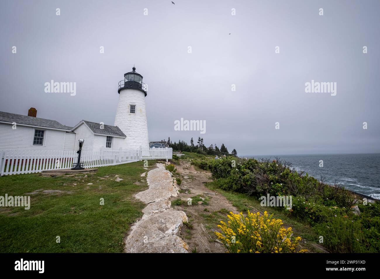 The lighthouse at Pemaquid Point, Maine with cloudy sky above and the ...